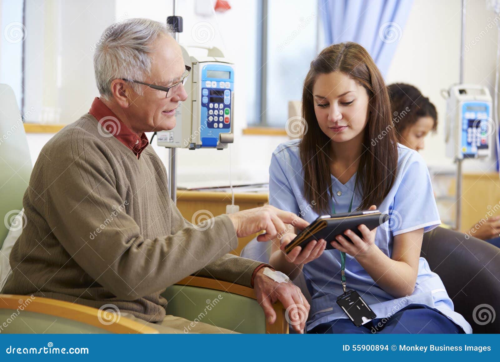 Man Having Chemotherapy with Nurse Using Digital Tablet Stock Photo ...