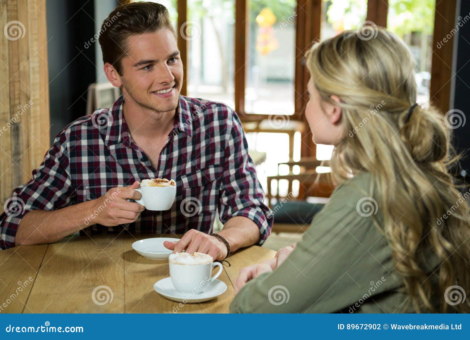 Man Having Coffee while Talking with Woman in Cafe Stock Photo - Image ...