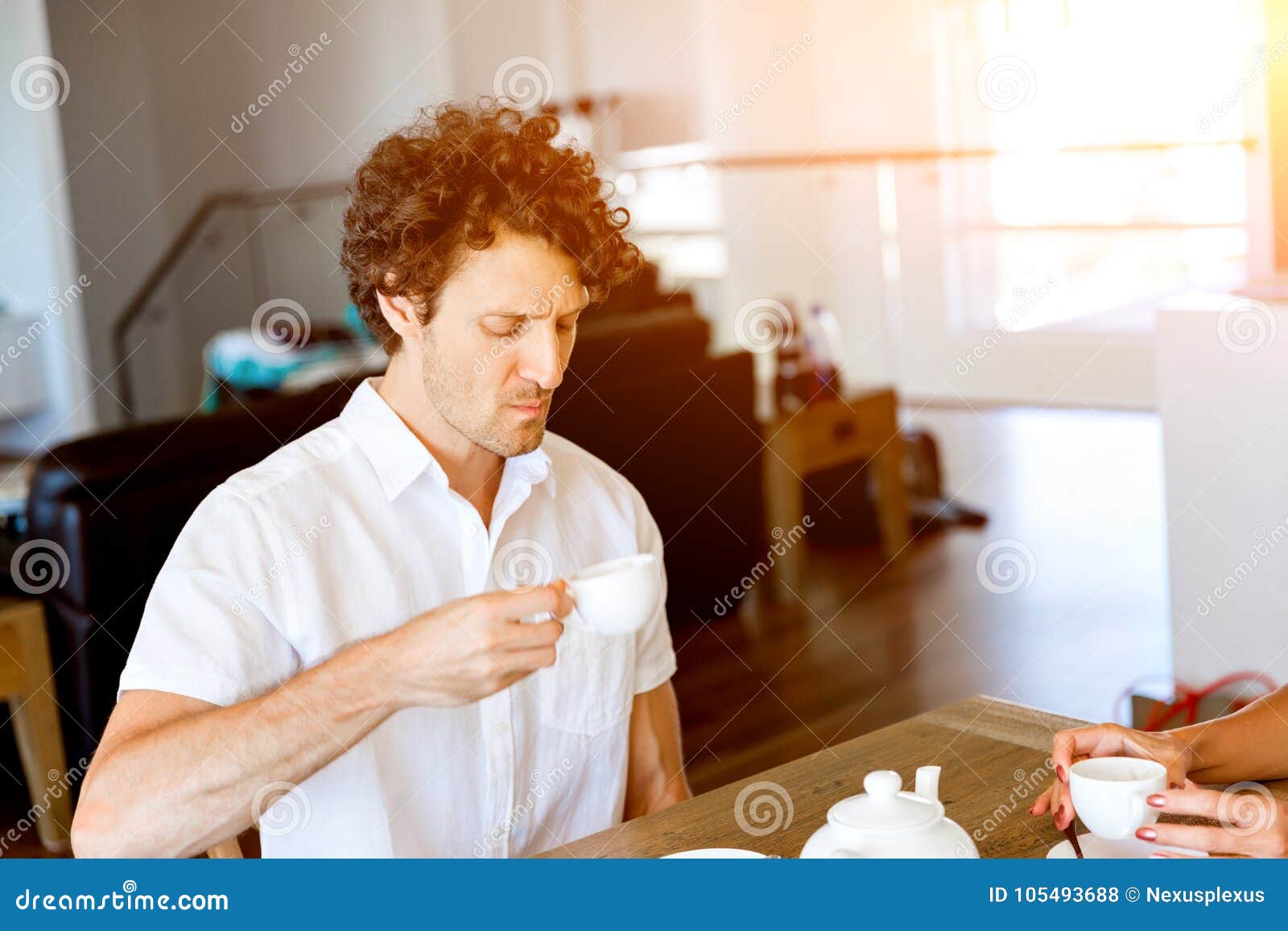 Man having tea at home stock photo. Image of handsome - 105493688