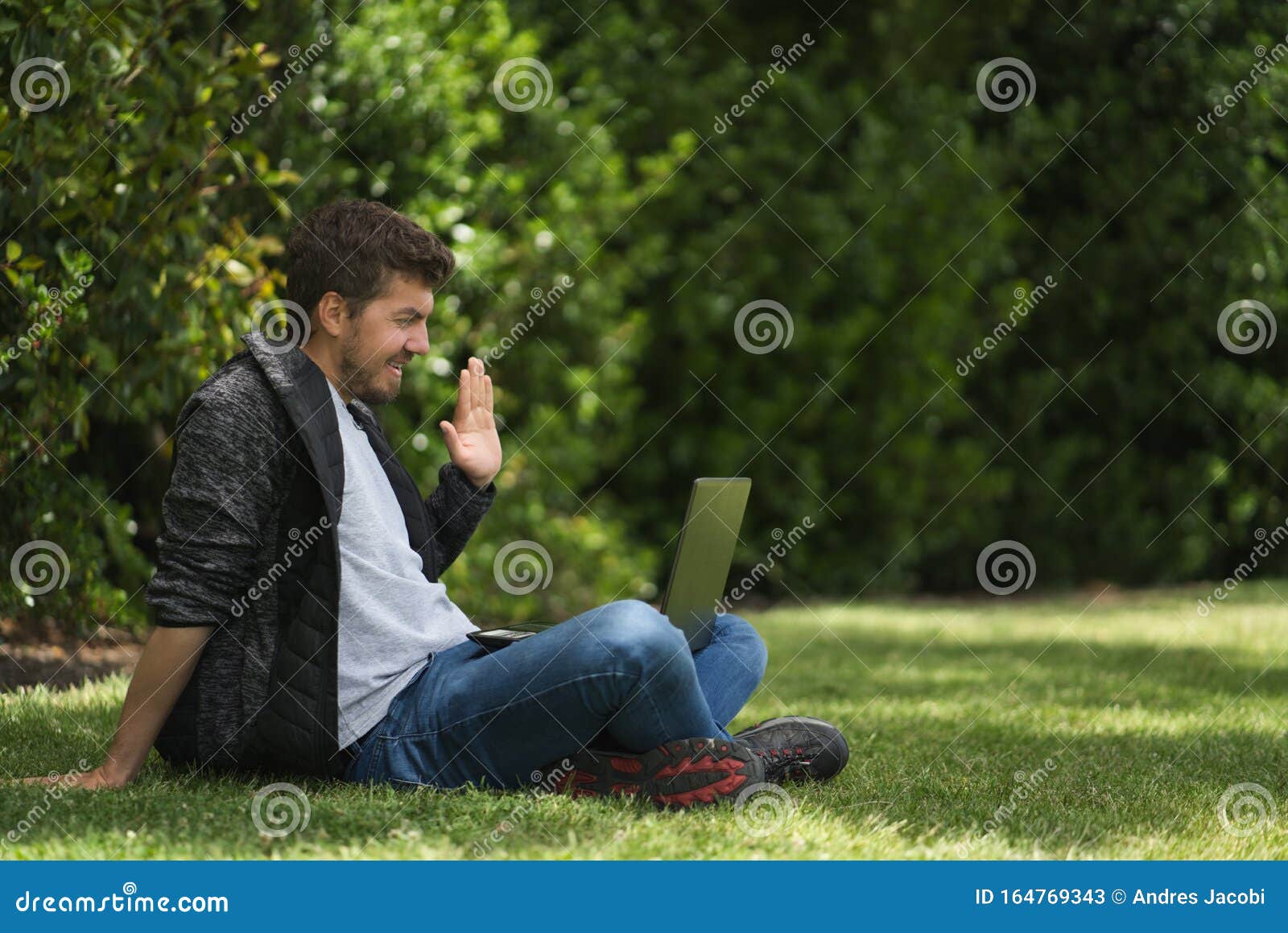 Man Having a Video Call with His Computer Saying Hello through the ...