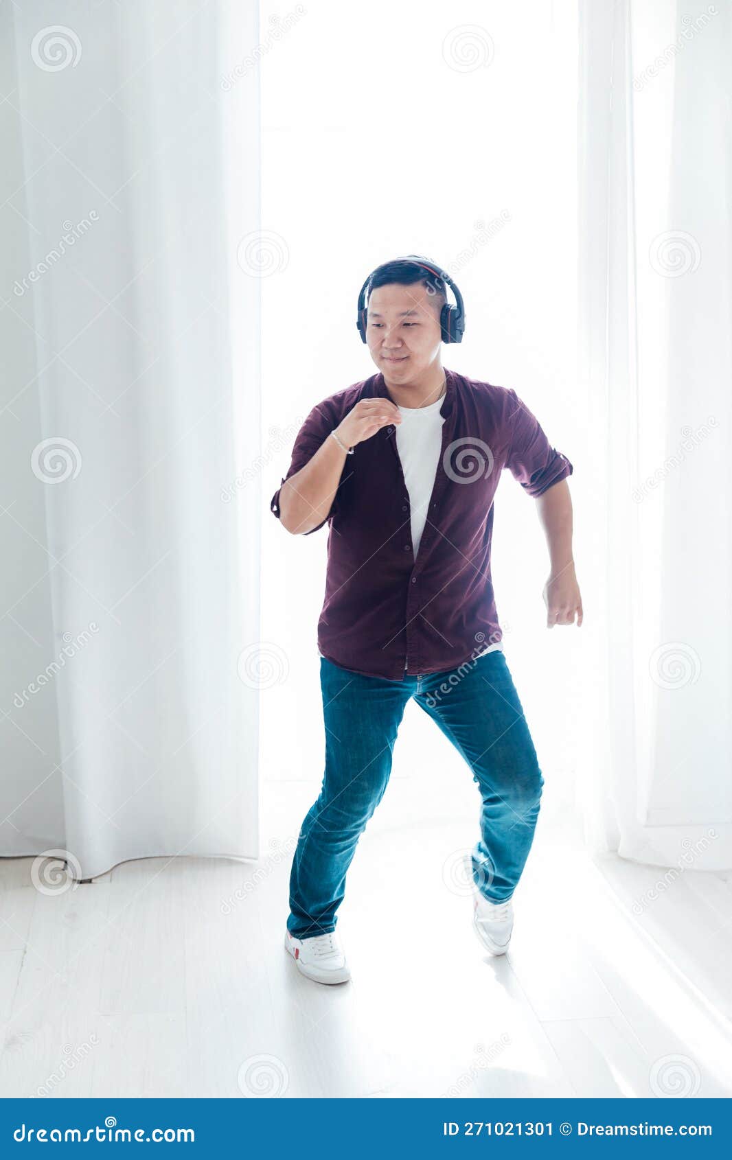 A Man in Headphones Dancing To Music in the Studio Hall Stock Image ...