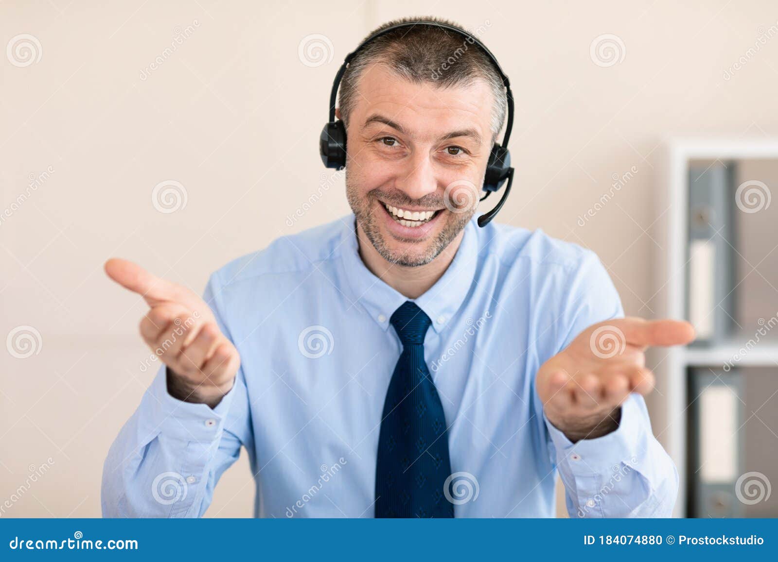 Man in Headset Smiling Sitting in Customer Support Office Stock Photo ...