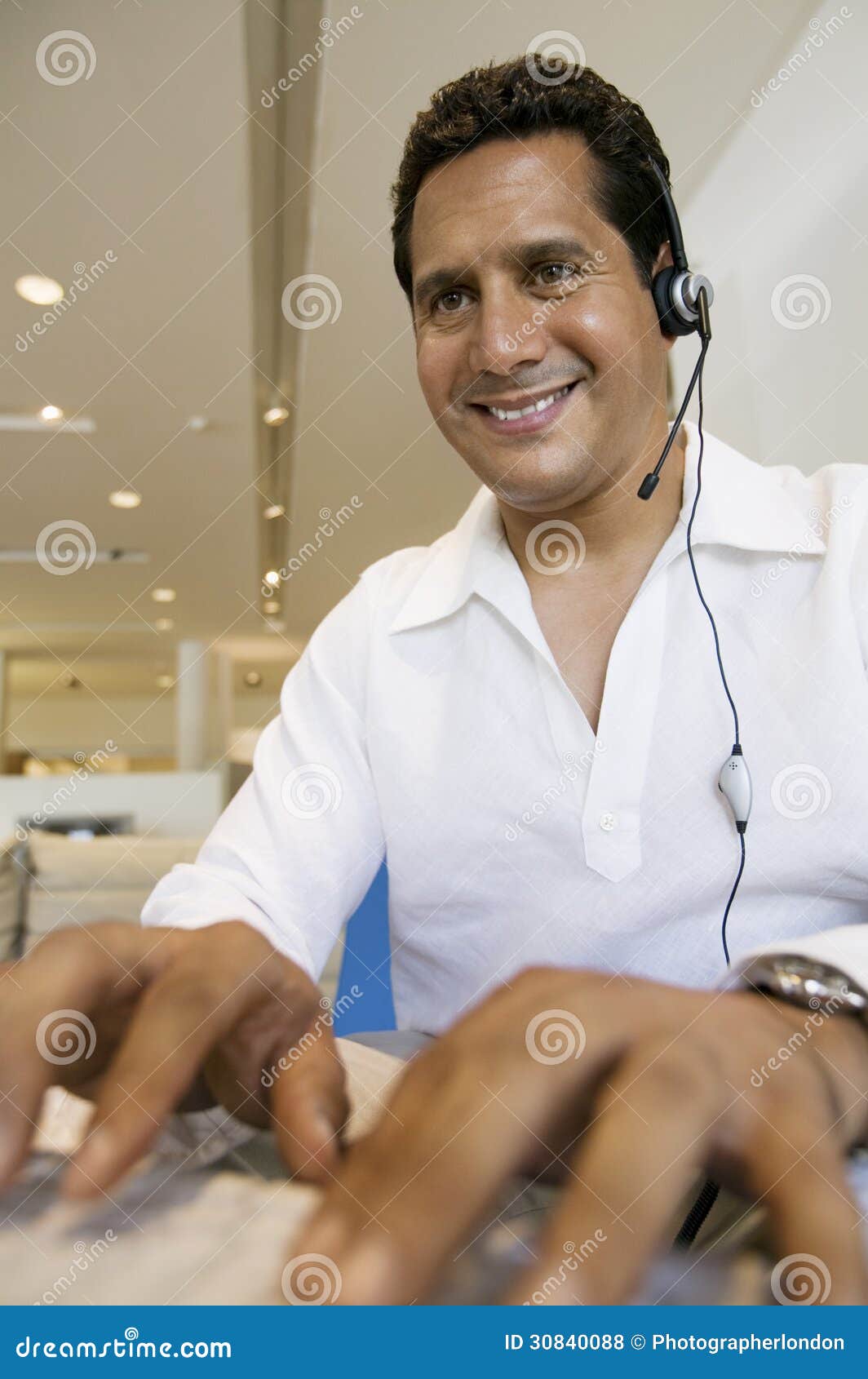 Man with Headset Working on Computer in Office Stock Photo - Image of ...