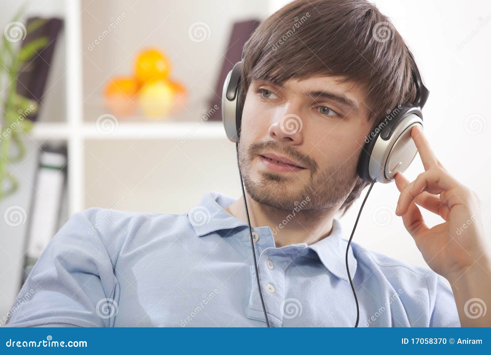 Man hearing music at home stock photo. Image of male - 17058370
