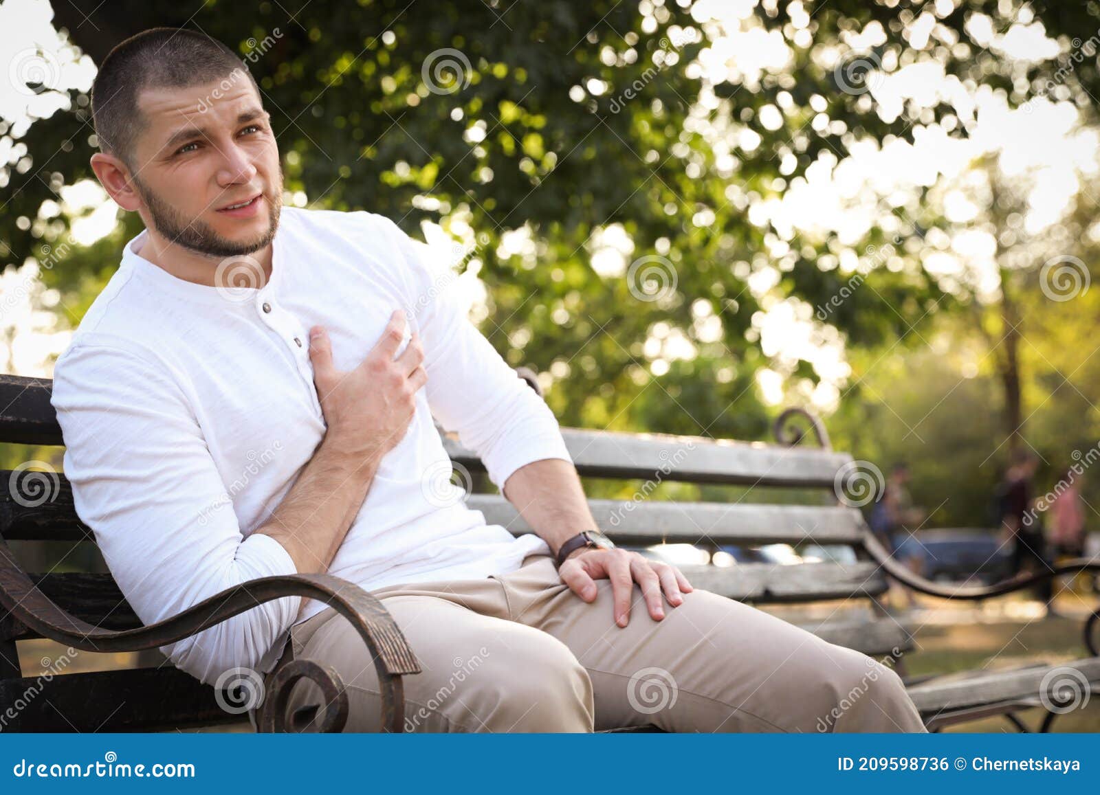 Man with Heart Attack Sitting on Bench in Park Stock Photo - Image of ...