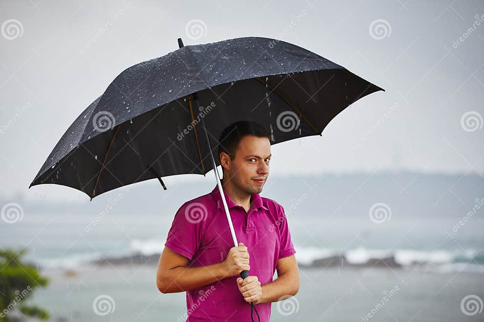 Man in heavy rain stock photo. Image of downpour, covering - 40032066