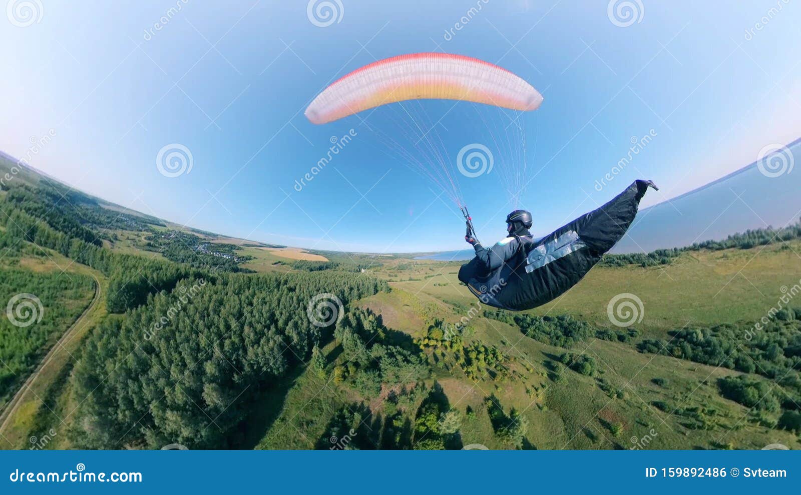 A Man in Helmet Flying with Paraplane Over Field. Stock Footage - Video ...