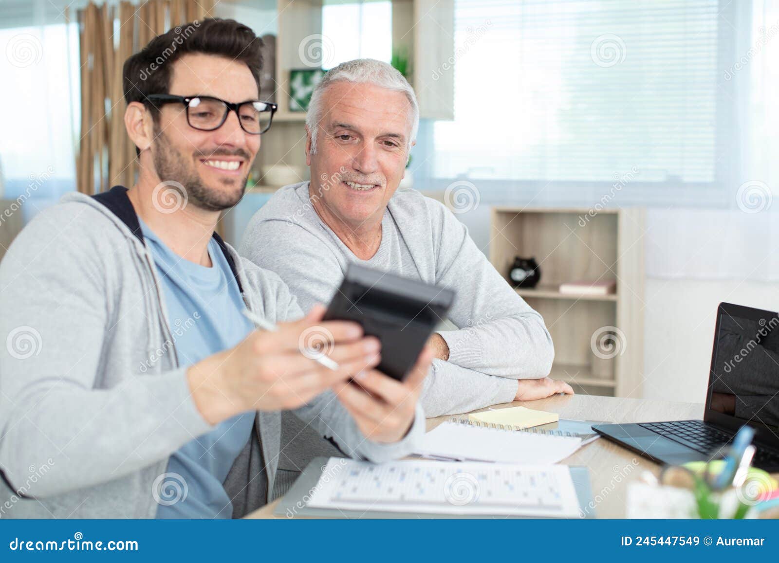 Man Helping Senior Neighbor with Paperwork Stock Image - Image of male ...