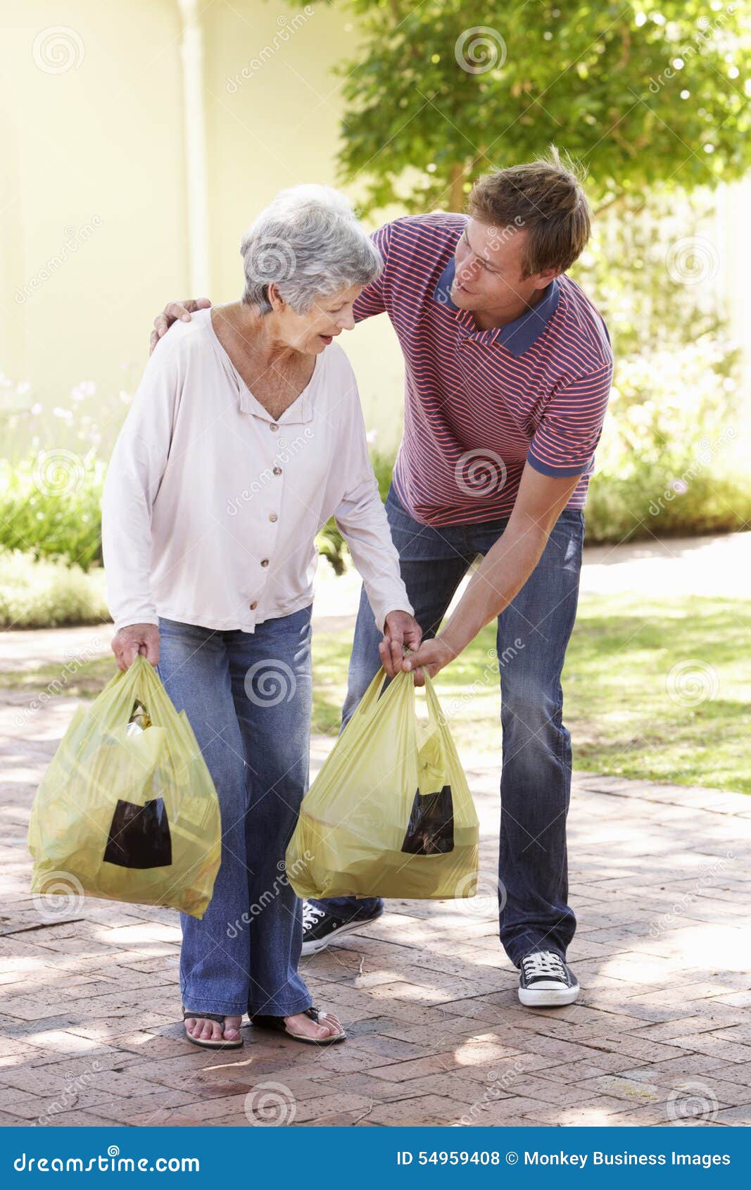 Woman Helping An Older Man In The Orchard, To Pick Apple Stock ... Woman Helping An Older Man In The Orchard, To Pick Apple Stock ...
