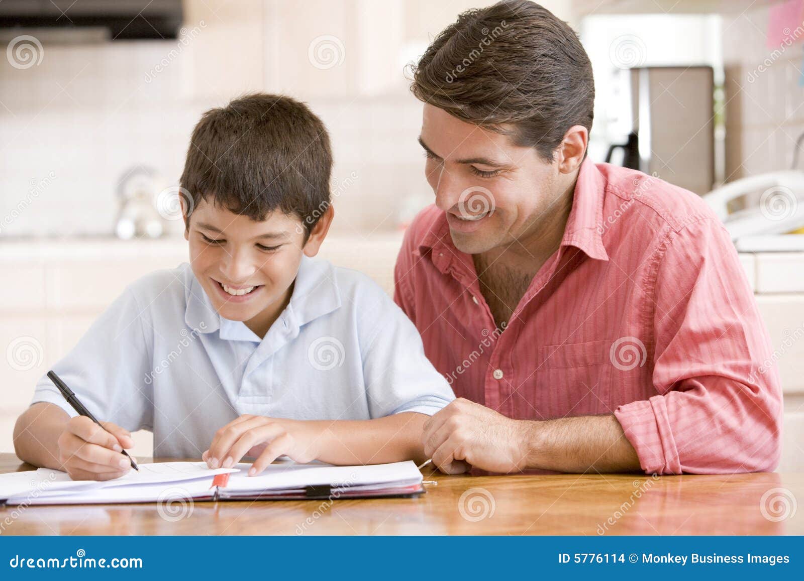 Man Helping Young Boy in Kitchen Doing Homework an Stock Photo - Image ...