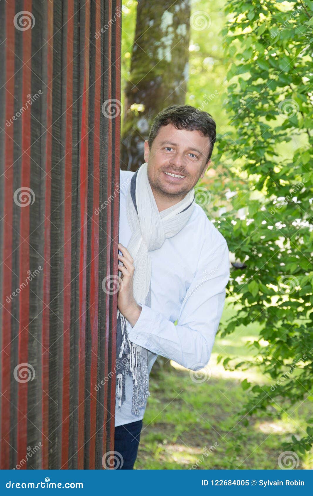 Man is Hiding Behind a Wooden Hut Stock Image - Image of male, green ...