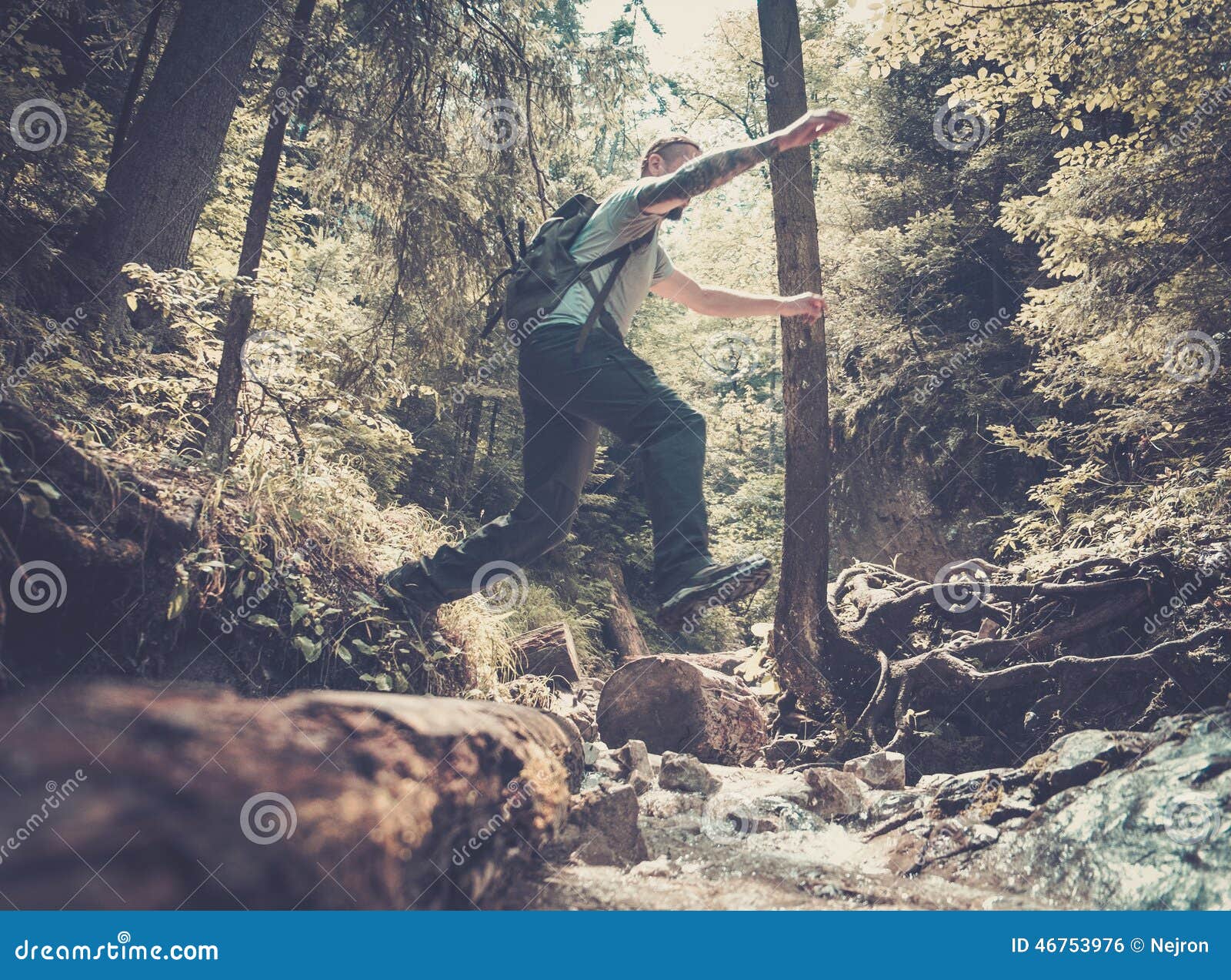 Man Hiker Jumping Across Stream Stock Photo - Image of adventurer ...