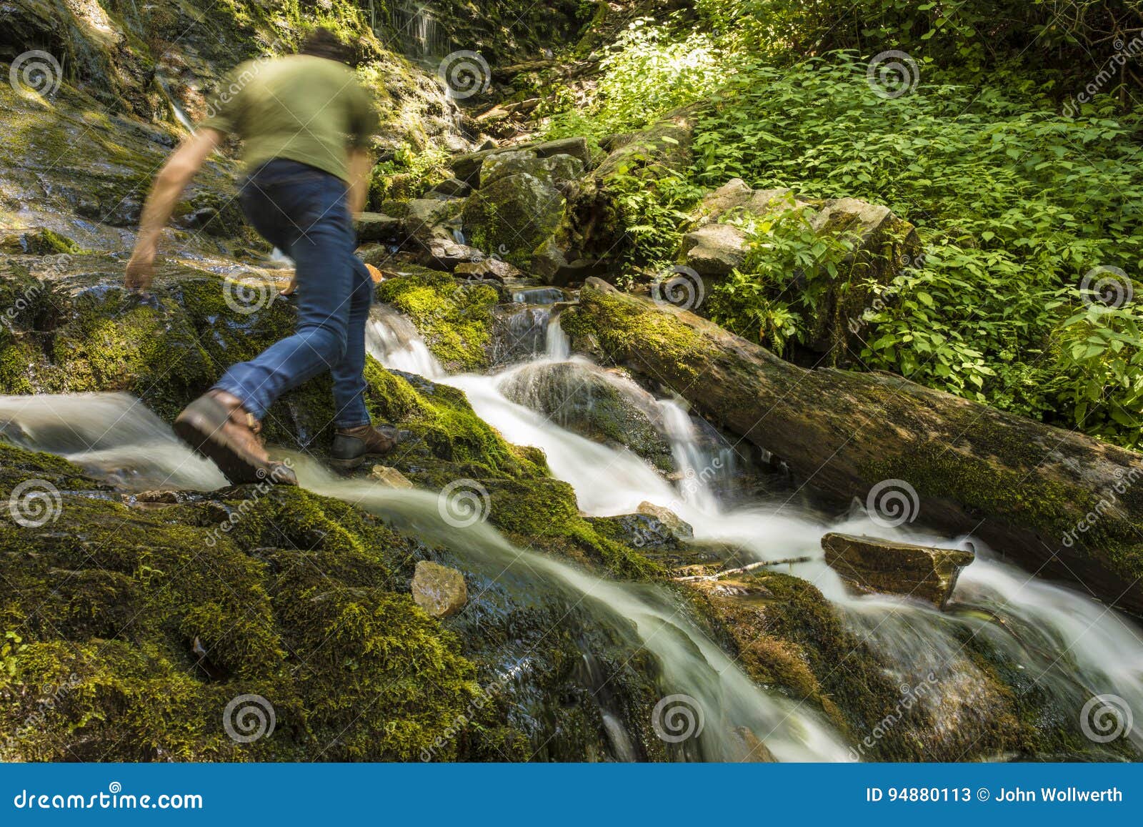 Man Hiking Over Waterfall with Motion Blur. Stock Image - Image of ...