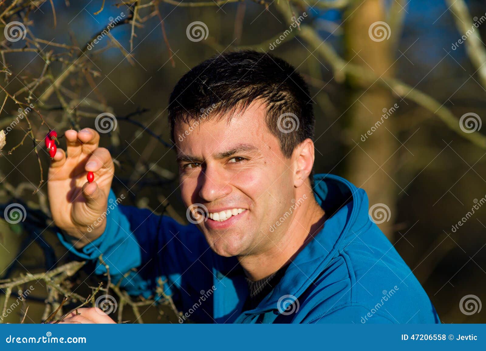 Man with hip roses stock photo. Image of autumn, park - 47206558