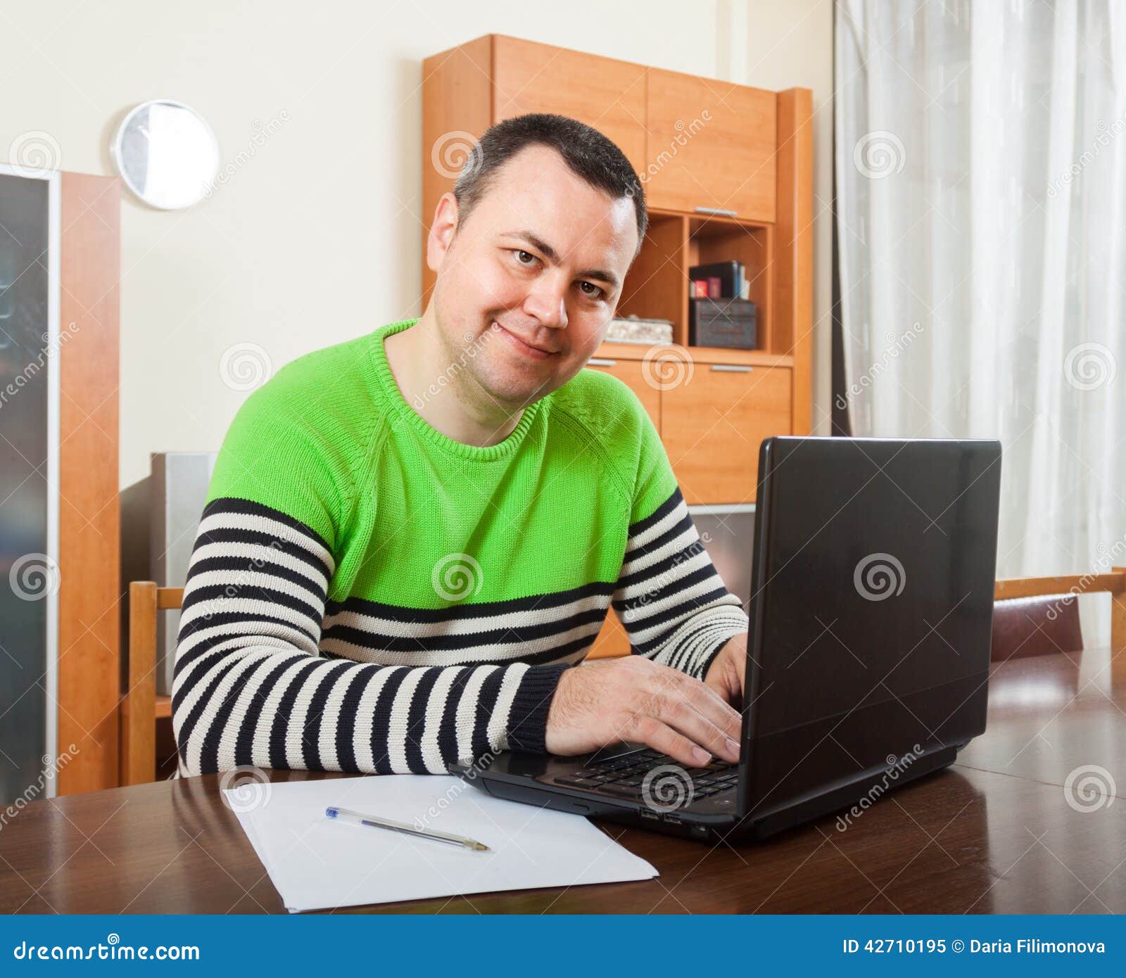 Man at his laptop at home. stock image. Image of person - 42710195