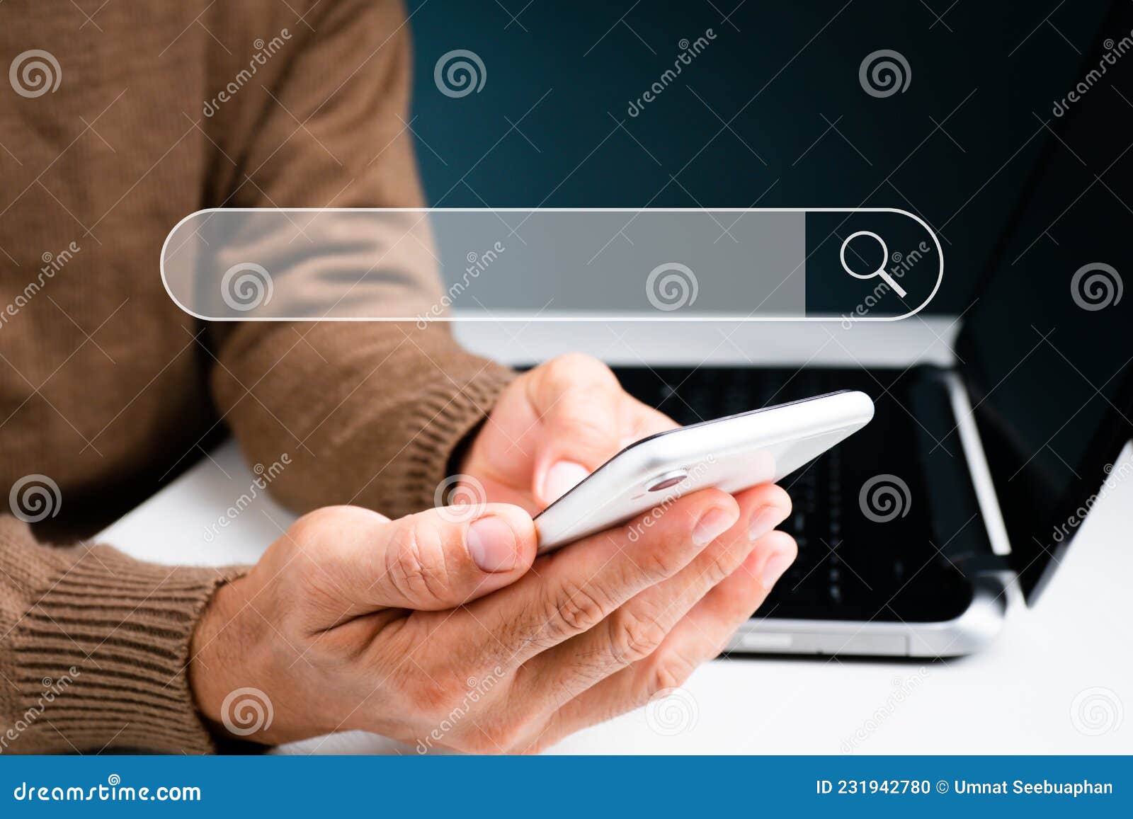 The Man is on His Phone while Works on a Laptop Computer. with a Blank ...