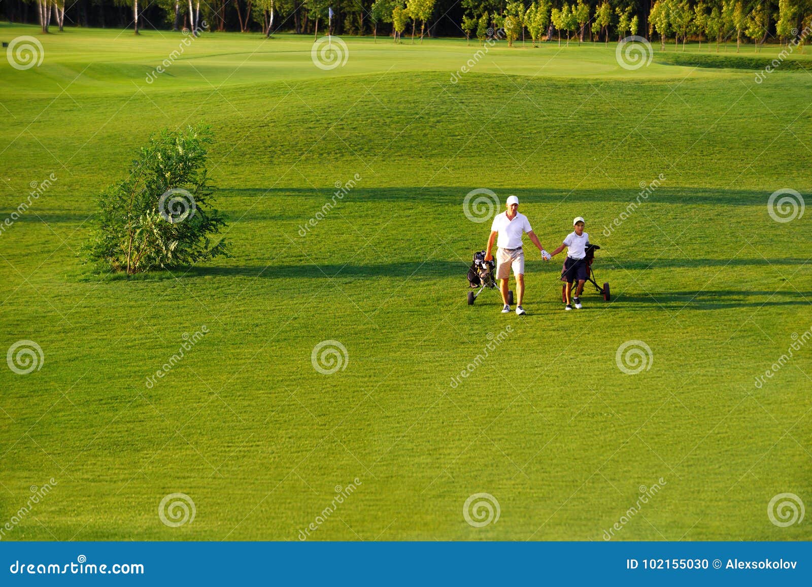 Man with His Son Golfers Walking on Golf Course Stock Photo - Image of ...