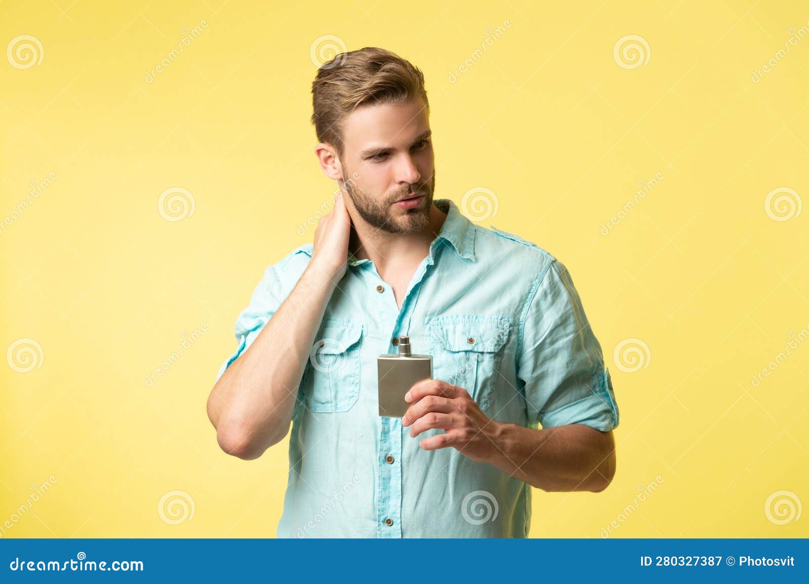Man Hold Cologne Isolated on Yellow. Man Hold Cologne in Studio ...