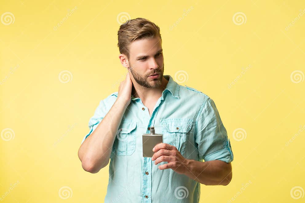 Man Hold Cologne Isolated on Yellow. Man Hold Cologne in Studio ...