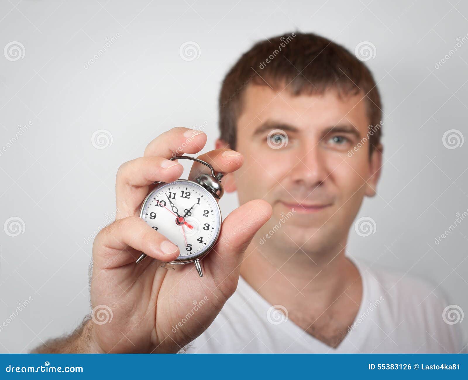 Man holding alarm clock stock photo. Image of background - 55383126