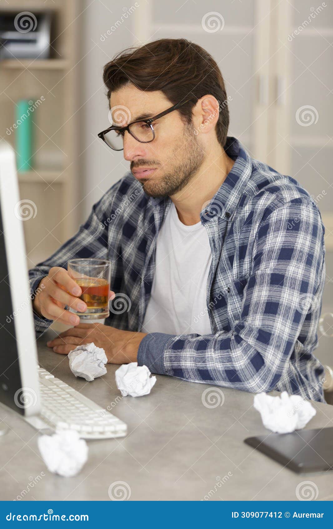Man Holding Alcoholic Drink Looking at Laptop Stock Photo - Image of ...