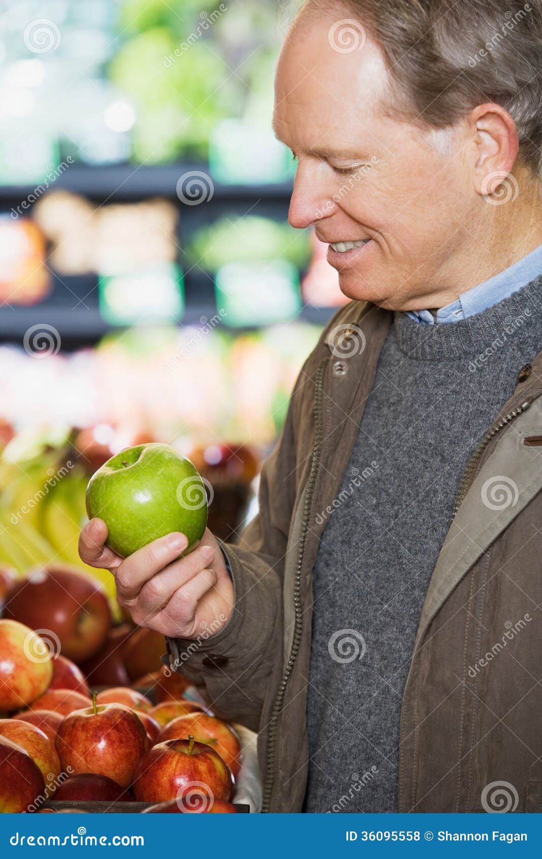 A man holding an apple stock photo. Image of assorted - 36095558