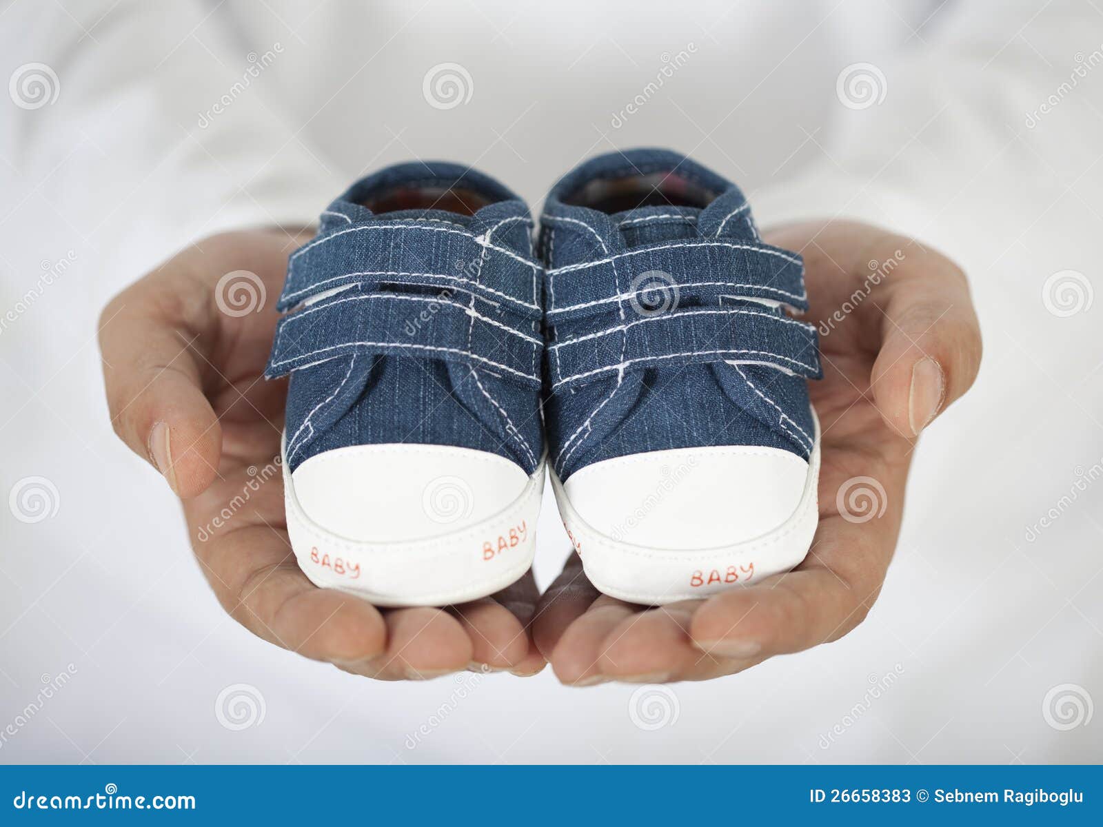 Man Holding Baby Shoes in White Stock Image - Image of tenderness ...