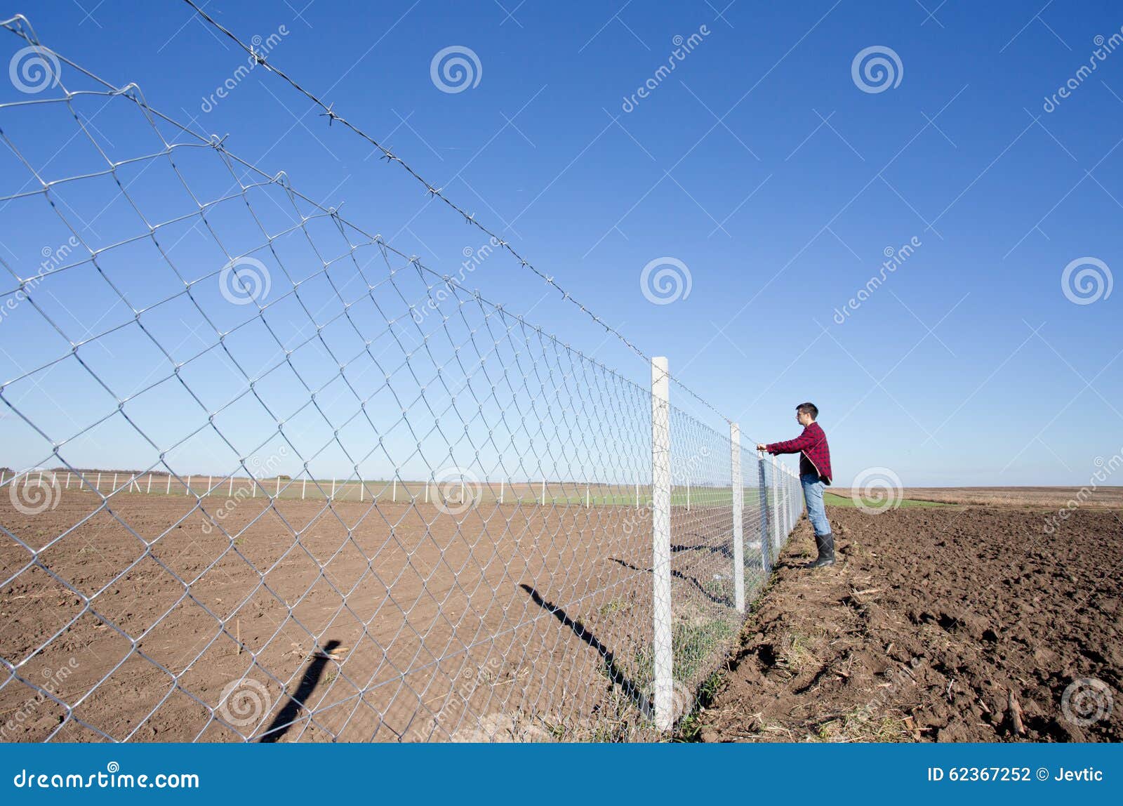 Man Holding Barbed Wire Fence Stock Photo - Image of boarder, diversity ...