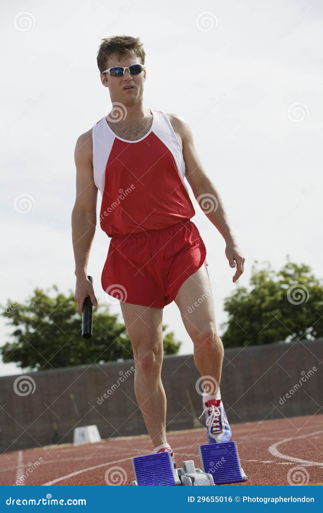 Man Holding Baton on Racing Track Stock Photo - Image of practice, male ...