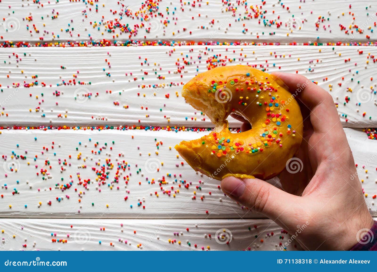 Man holding bitten donut stock photo. Image of colorful - 71138318