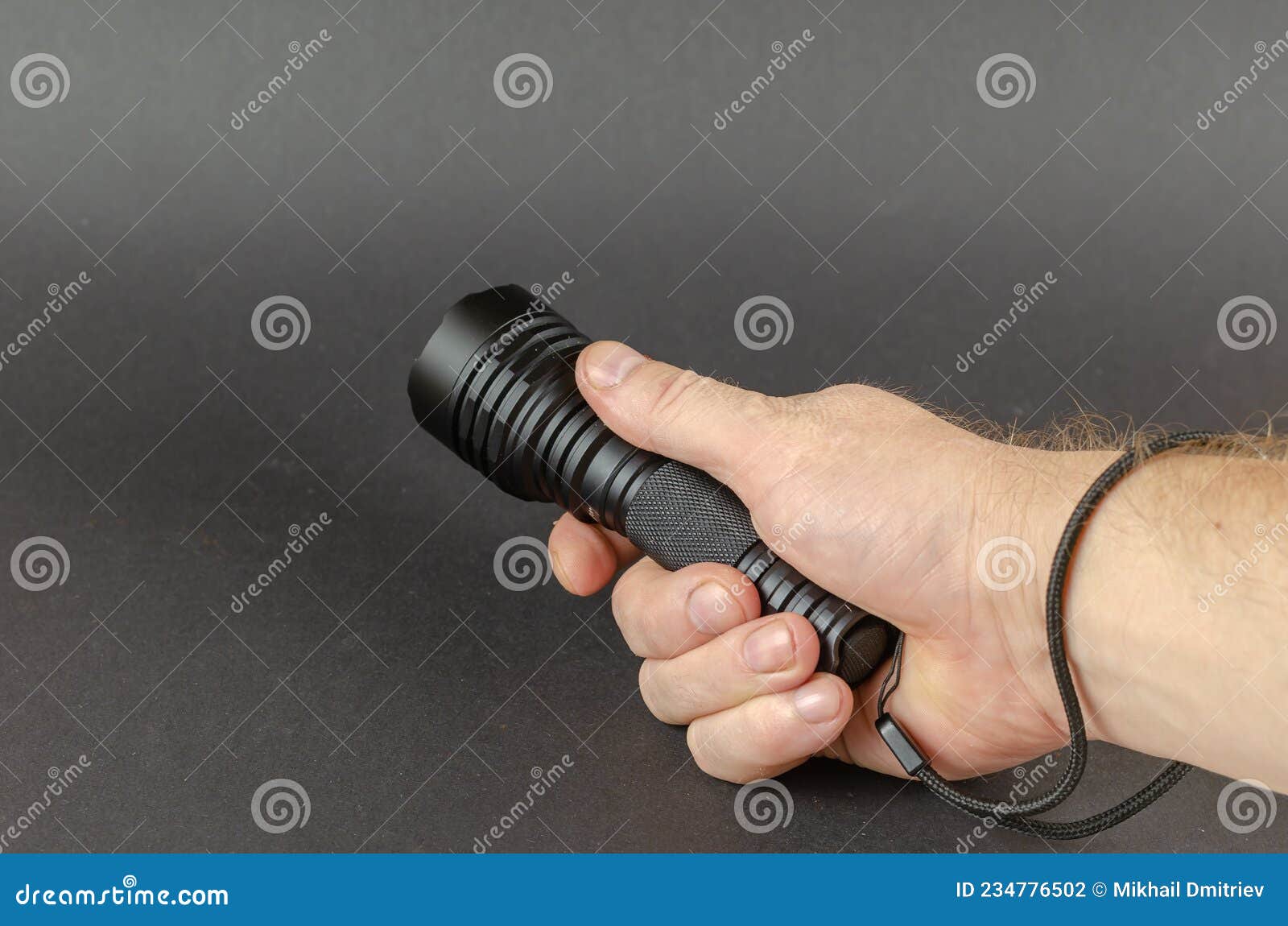 A Man is Holding a Black LED Hand Flashlight Stock Photo - Image of ...