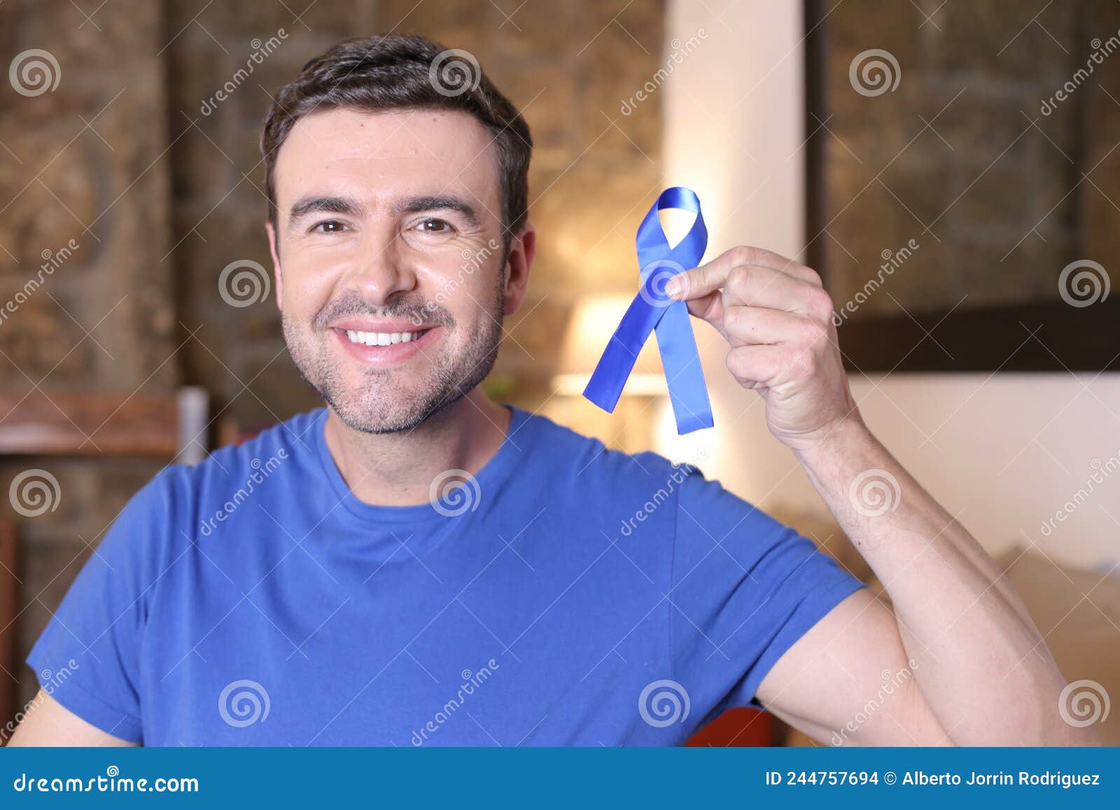 Man holding a blue ribbon stock photo. Image of help - 244757694