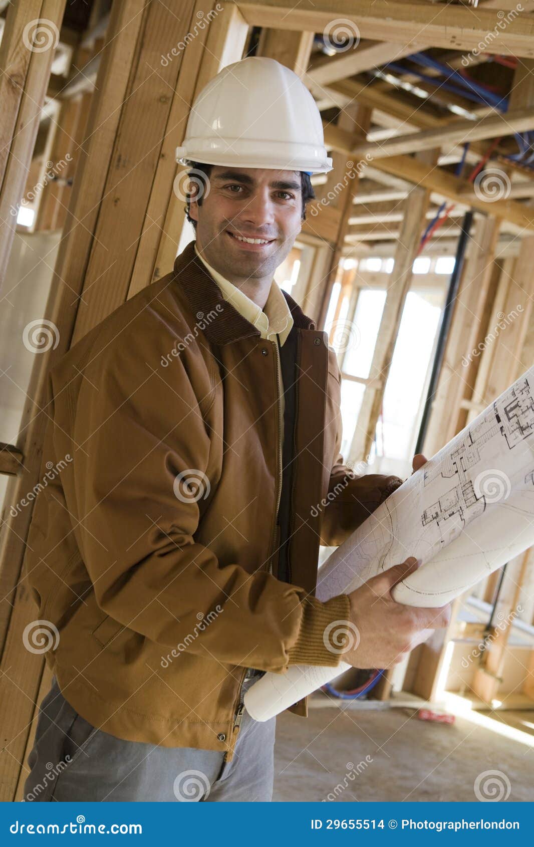 Man Holding Blueprint in Construction Site Stock Photo - Image of ...