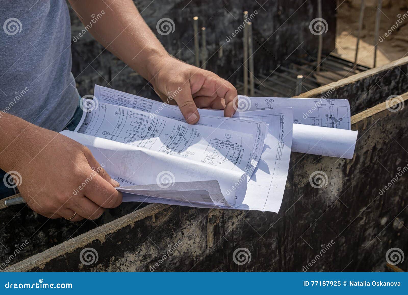 Man Holding Blueprints at Construction Site Stock Image - Image of ...