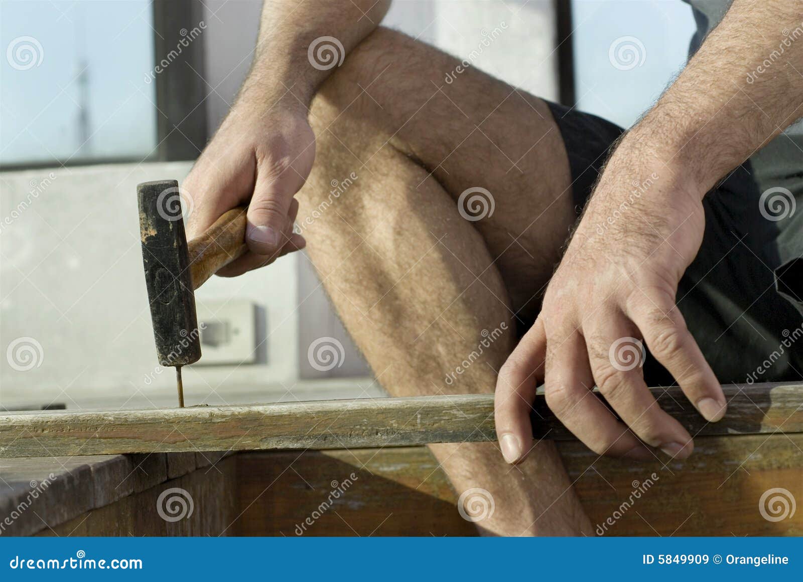 Man Holding Board while Hammering - Horizontal Stock Image - Image of ...