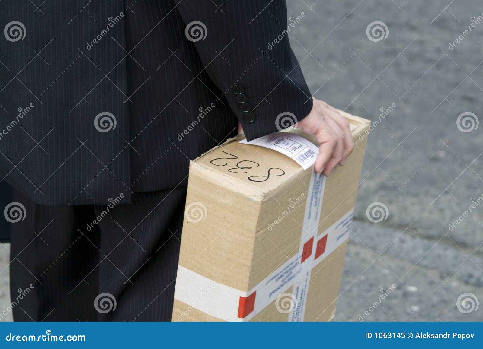 Man Holding Box stock image. Image of suit, hand, pinstripes - 1063145