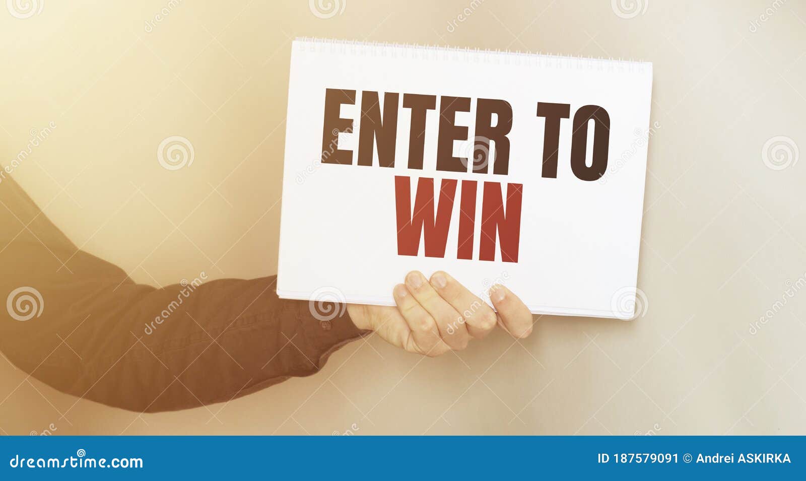 Man Holding Brochure with ENTER TO WIN Text on Grey Background. Mock Up ...