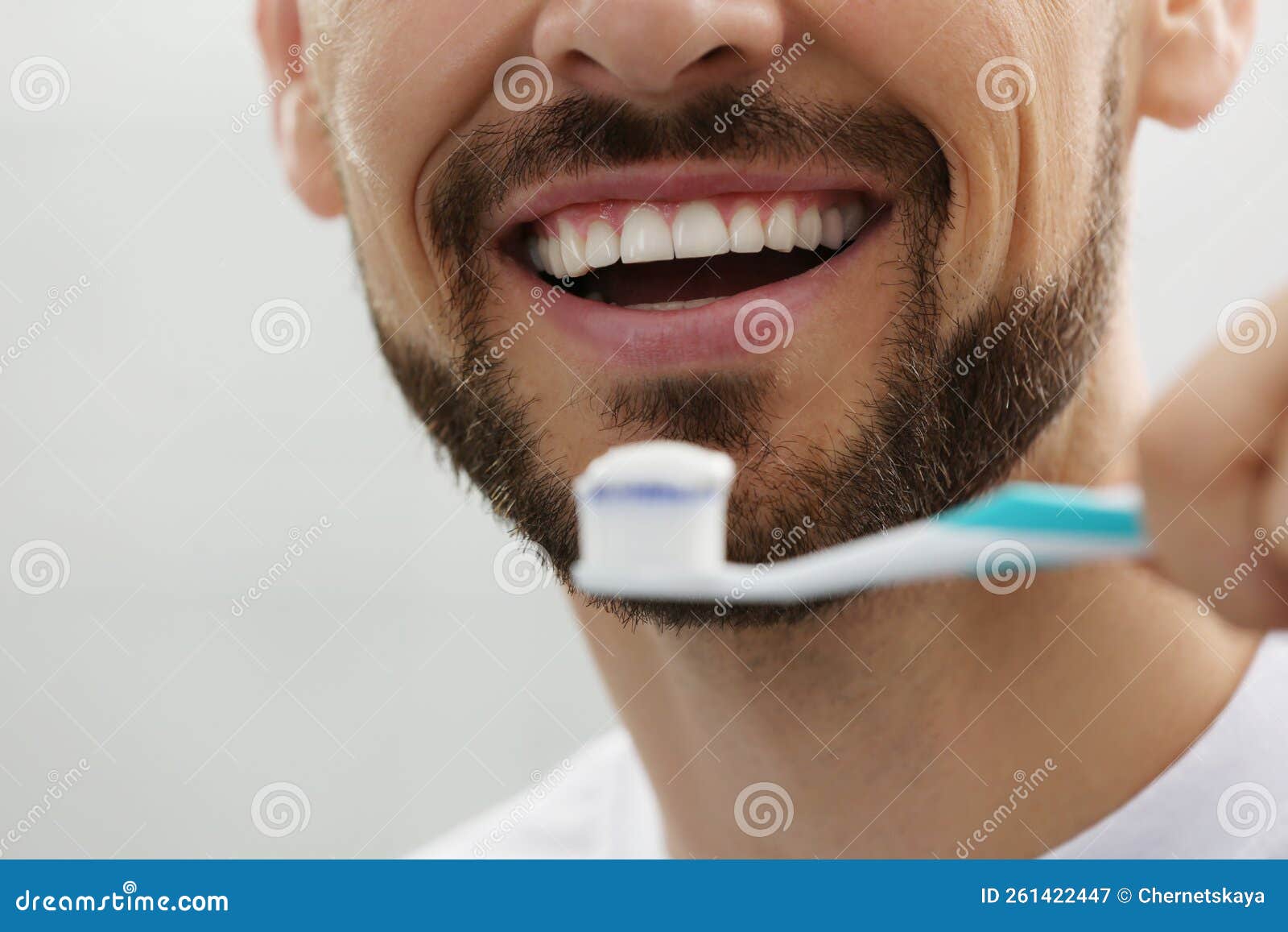 Man Holding Brush with Toothpaste on Grey Background, Closeup Stock ...