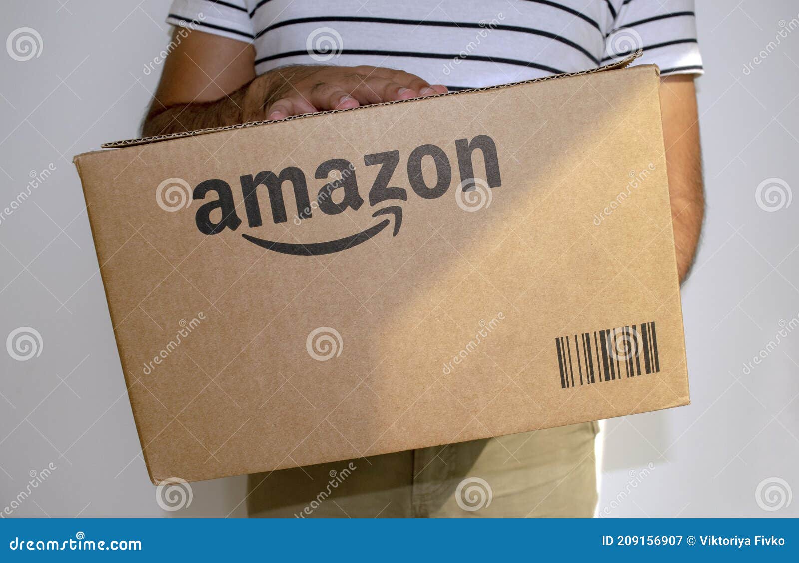 Man is Holding Cardboard Box Parcel of Amazon. Amazon Delivery Package ...