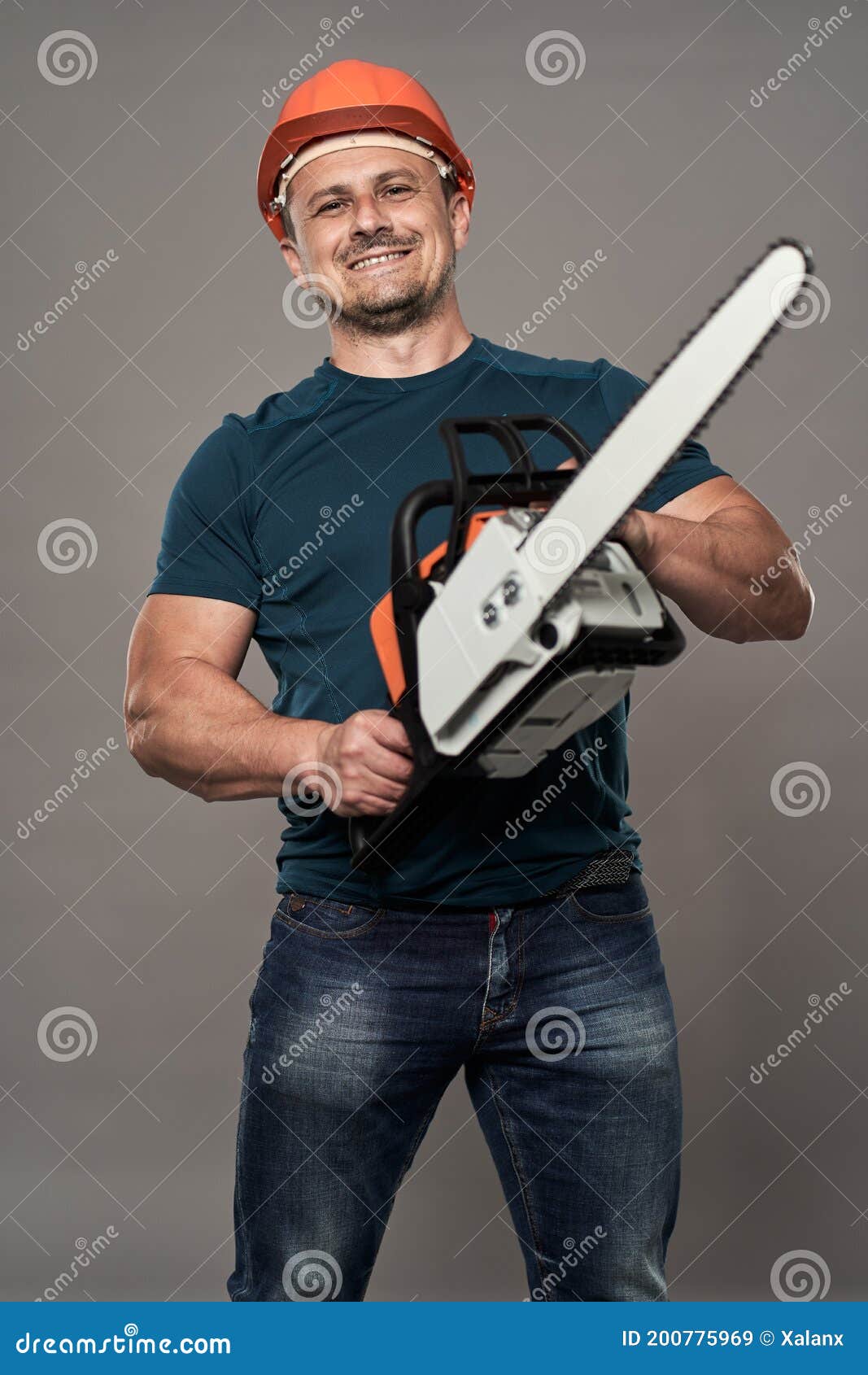 Man holding a chainsaw stock image. Image of hardhat - 200775969