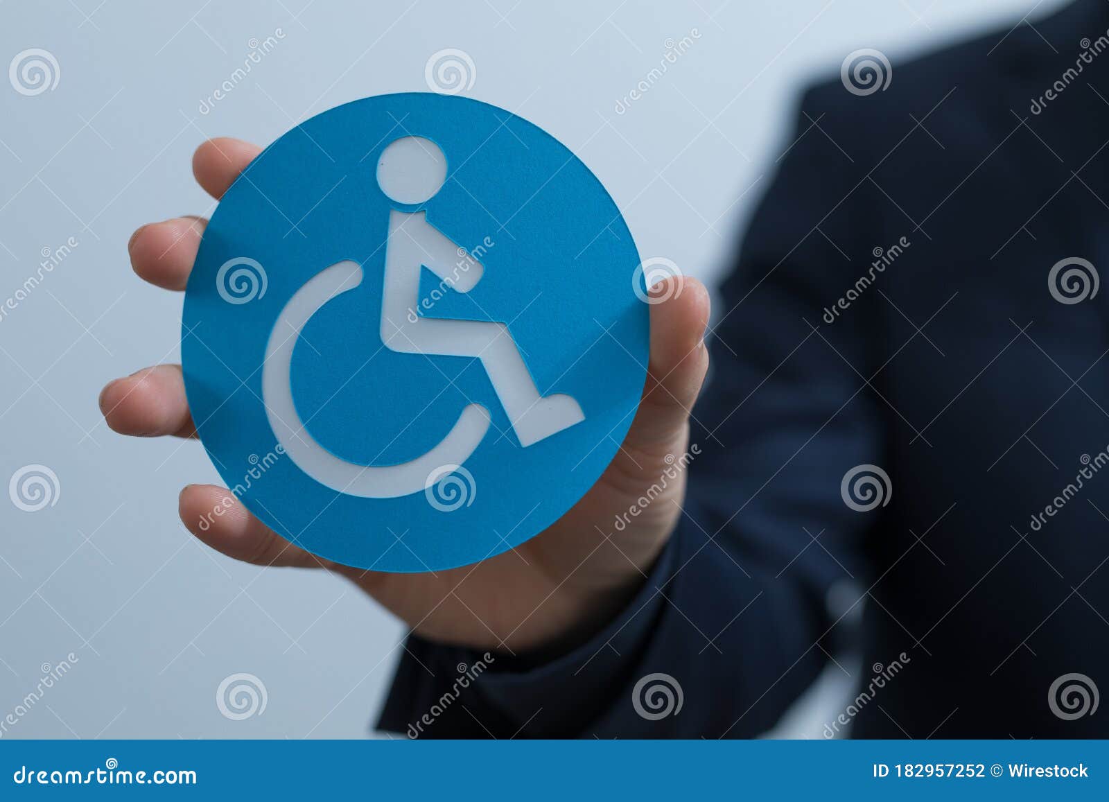 Man Holding a Circle Sign with a Disability Symbol Stock Photo - Image ...