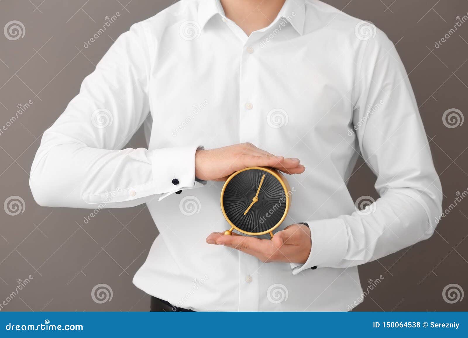 Man Holding Clock on Gray Background. Time Management Concept Stock ...
