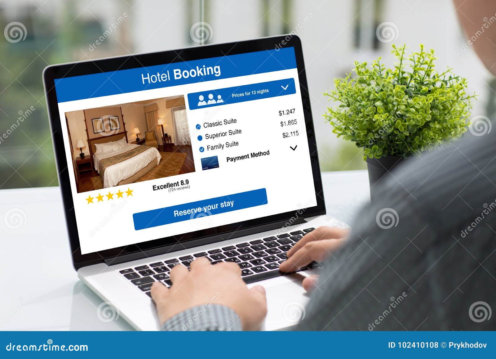 Man Holding Computer with App Hotel Booking Screen in Cafe Stock Photo ...