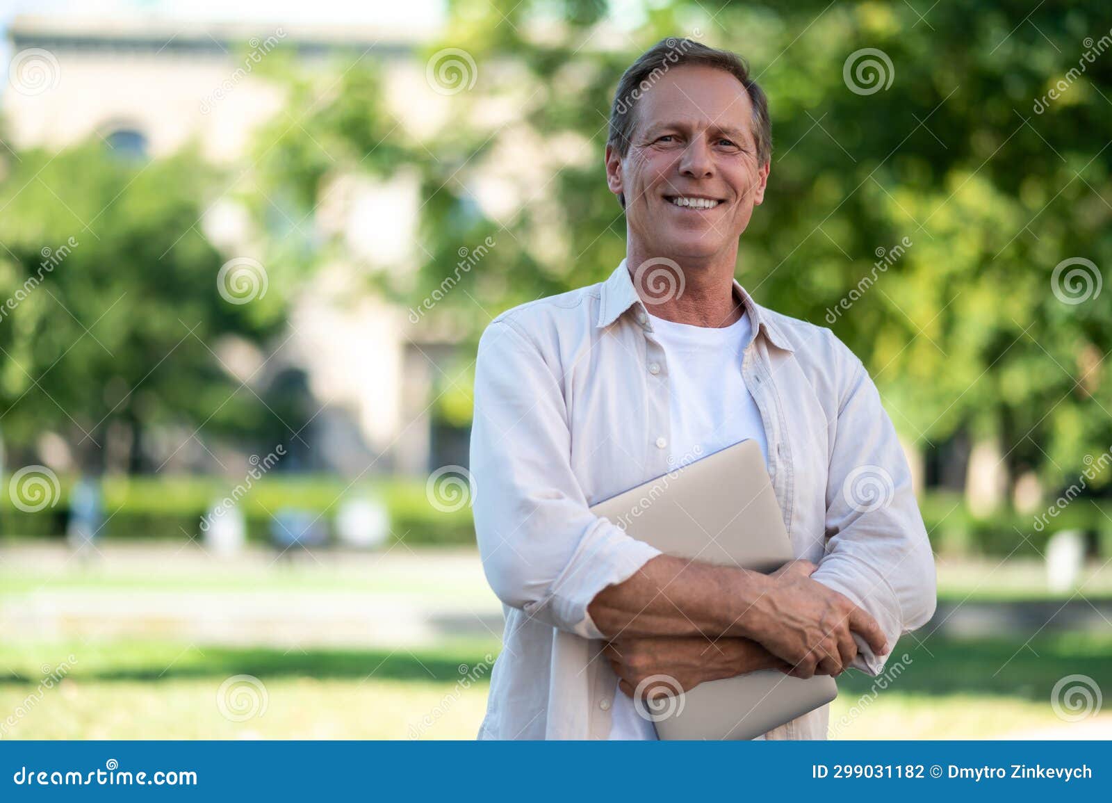 Man Holding Computer in City Park. Stock Photo - Image of friendly ...