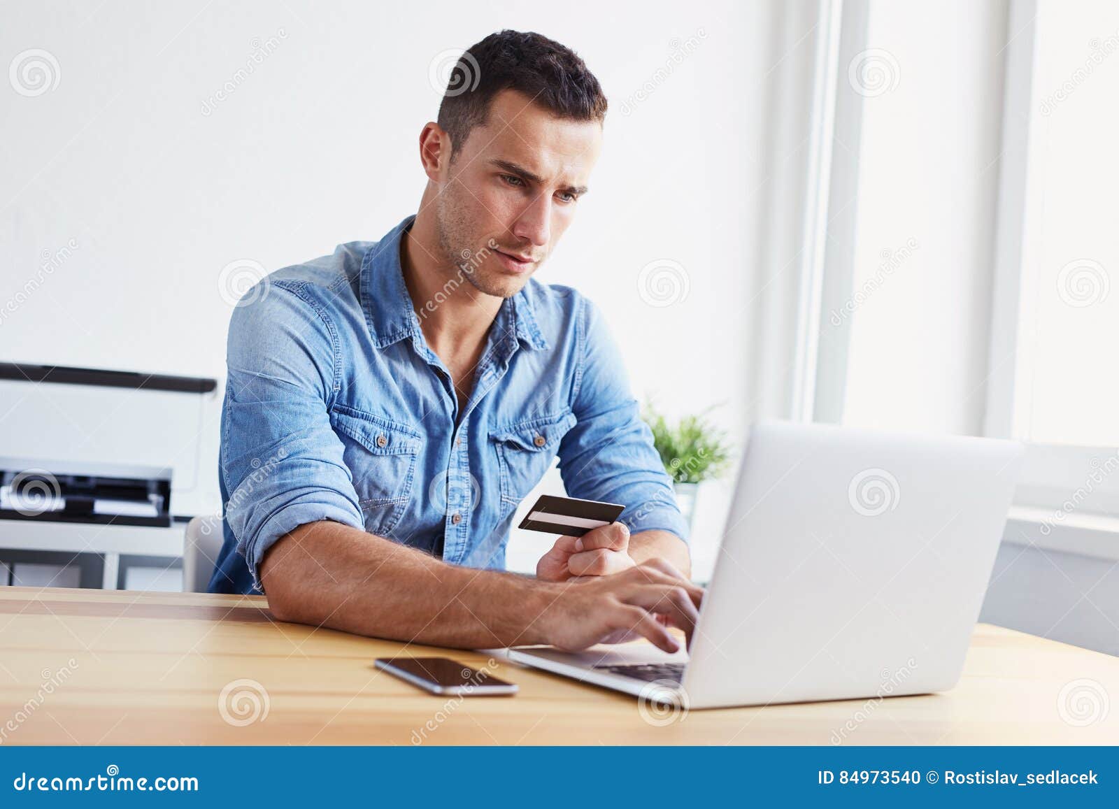 Man Holding Credit Card and Using Laptop Stock Photo - Image of ...