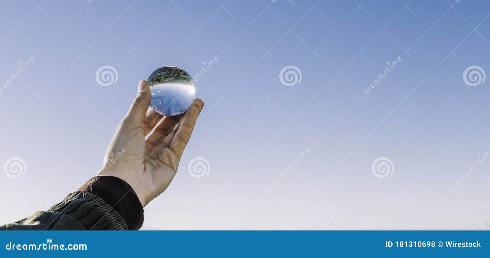 Man Holding a Crystal Ball in a Blue Clear Sky Stock Photo - Image of ...