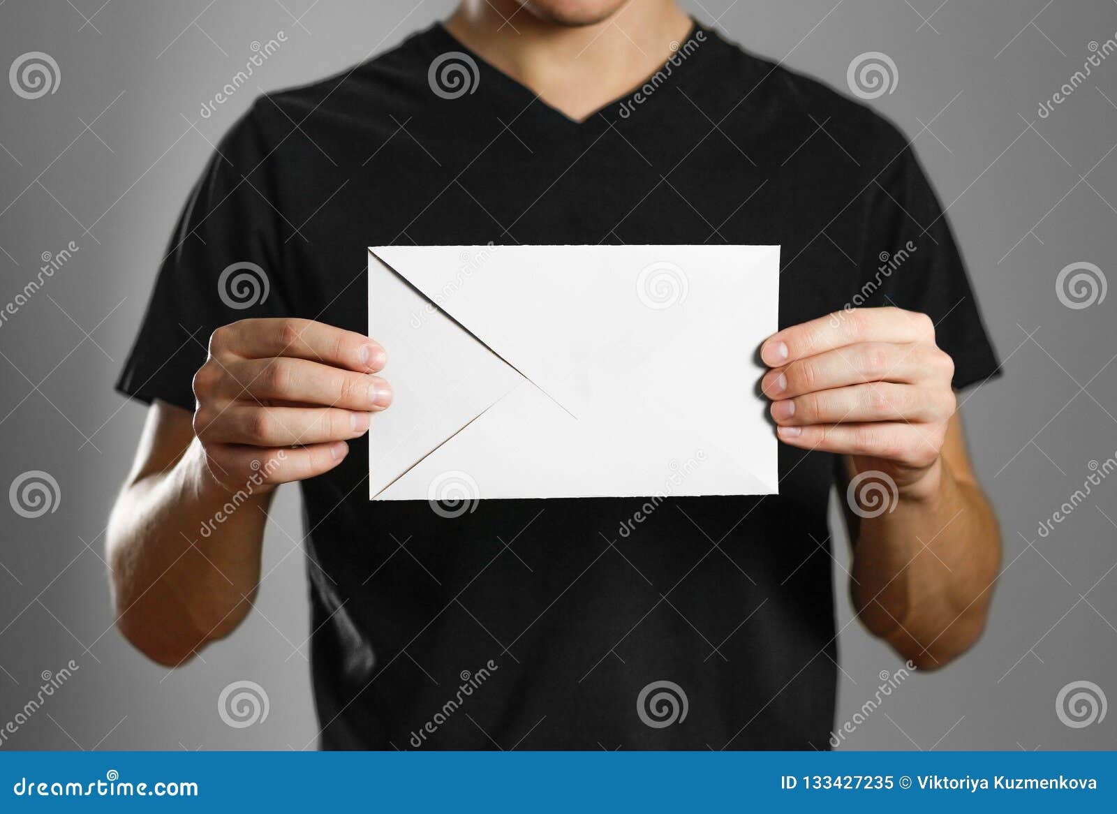 A Man Holding an Envelope. Isolated on Grey Background Stock Image ...