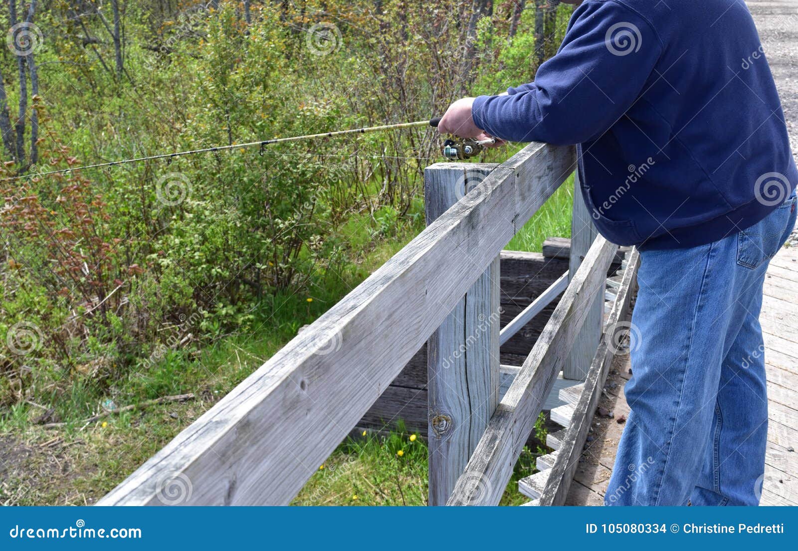 Man fishing from a bridge stock photo. Image of shore - 105080334