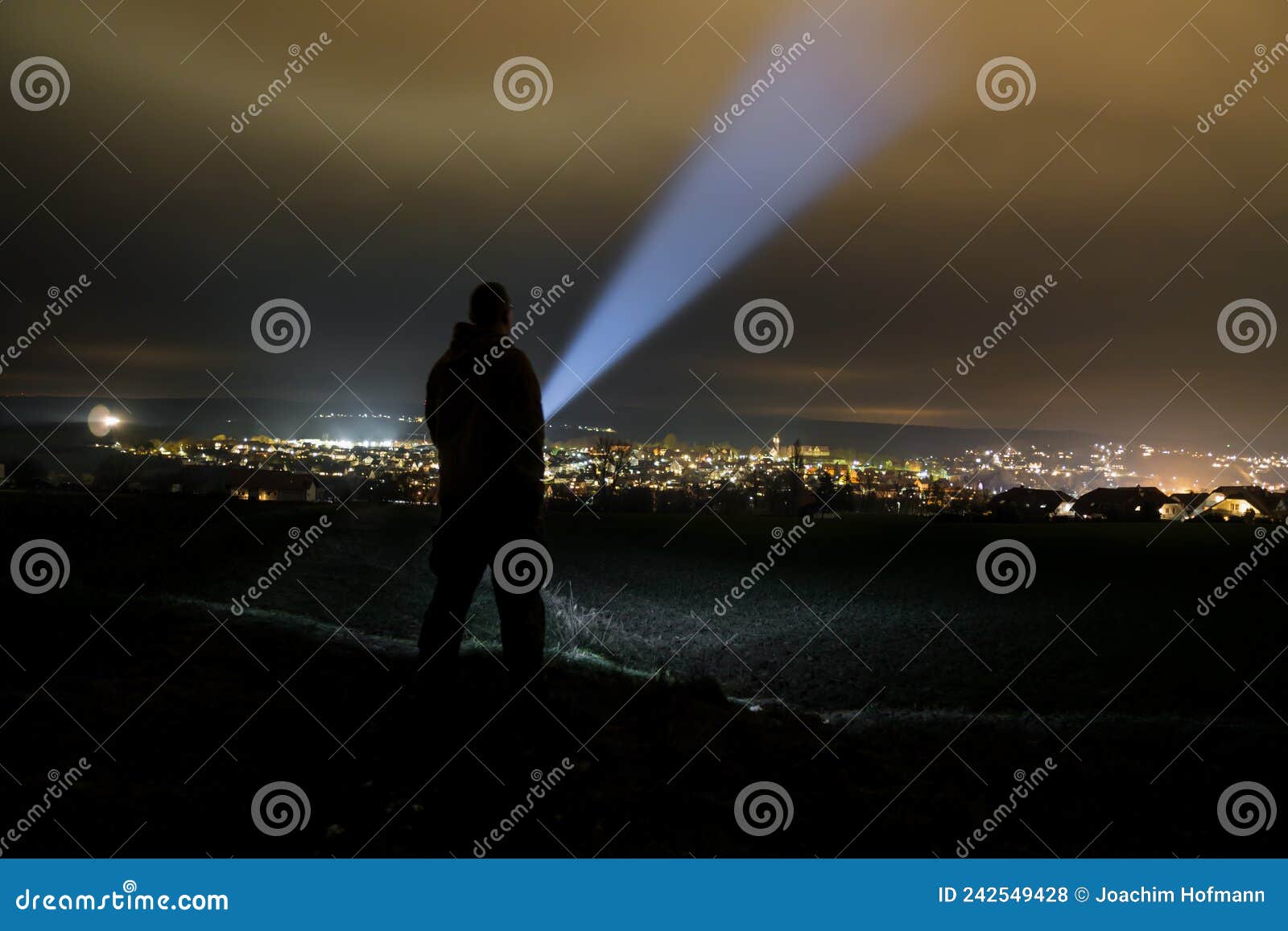 Man Holding a Flashlight and Illuminating the Sky Stock Photo - Image ...