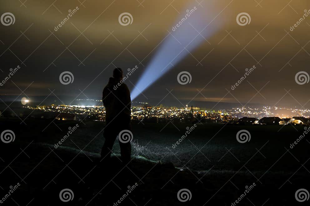 Man Holding a Flashlight and Illuminating the Sky Stock Photo - Image ...